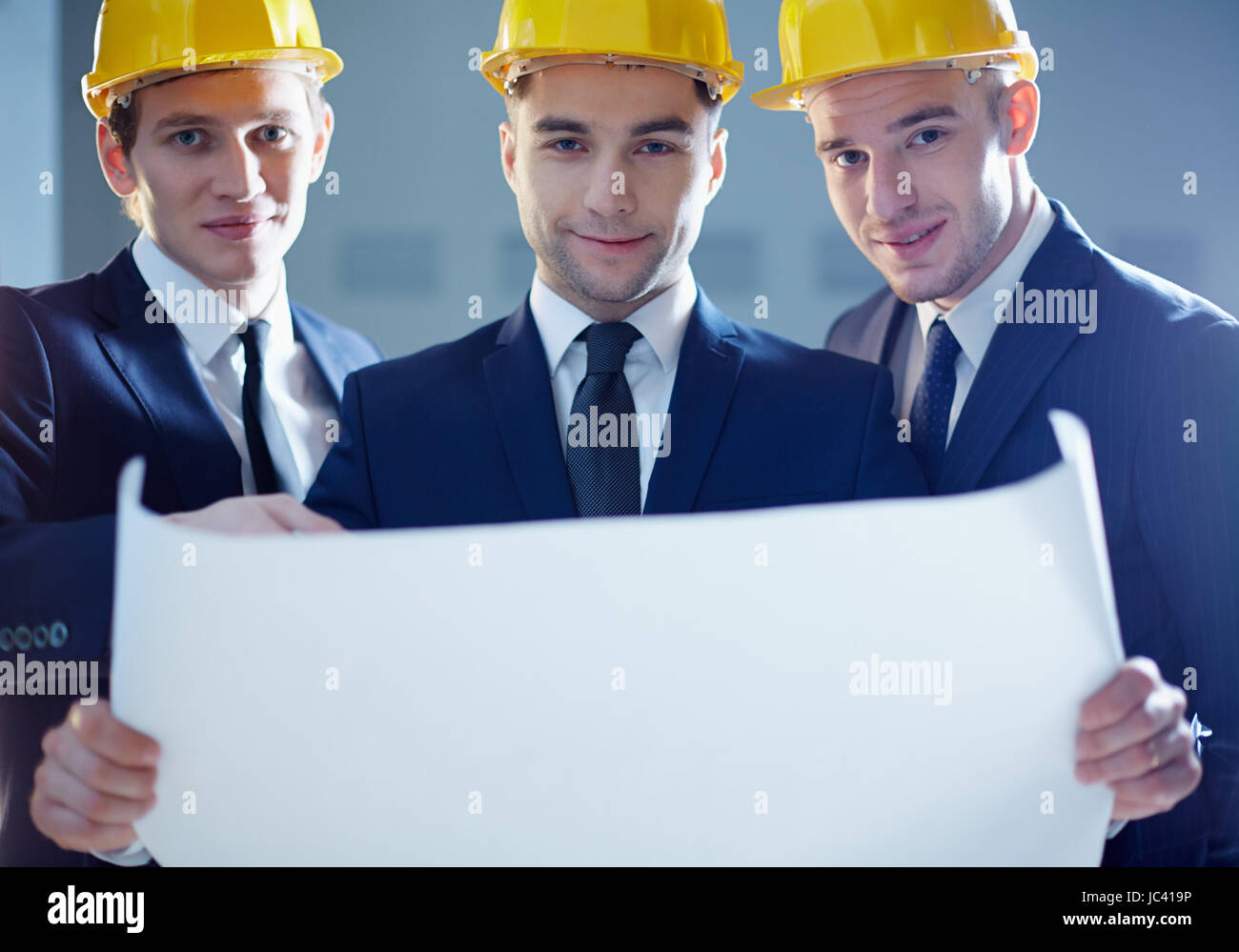 Three successful foremen with a blueprint Stock Photo - Alamy