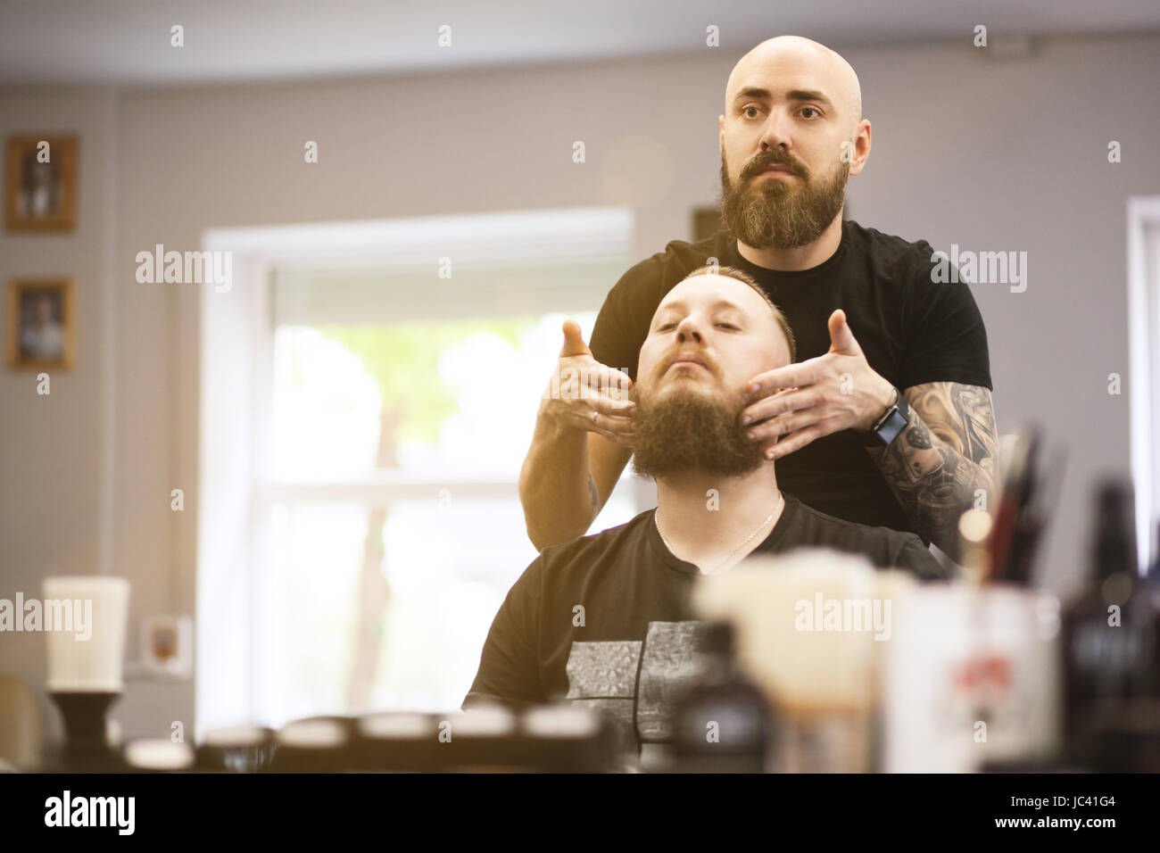 Barber doing hairstyle bearded man hi-res stock photography and images ...