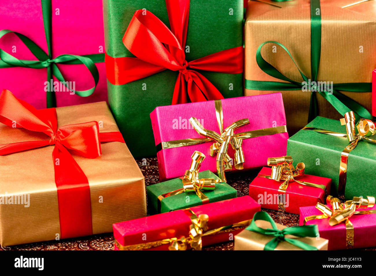 Plain-colored presents with bows in gold, red and green. Tightly framed ...