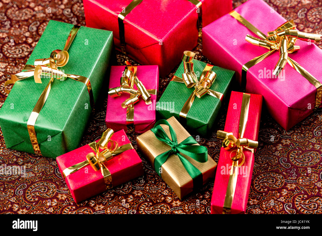 Plain-colored presents in different sizes. Wrapped in red, green, gold ...