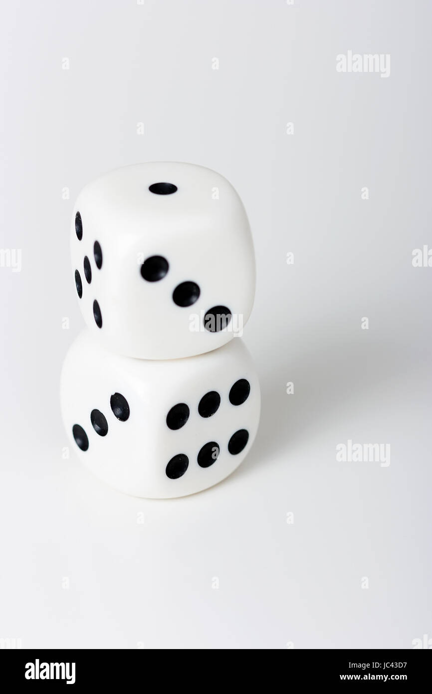 Two white dice with black dots on each other Stock Photo - Alamy