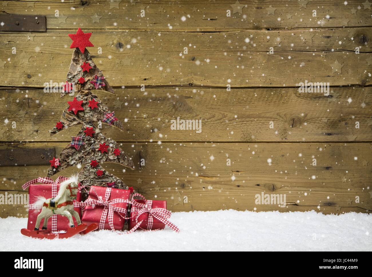 Christmas tree with red presents and snow on wooden snowy background ...