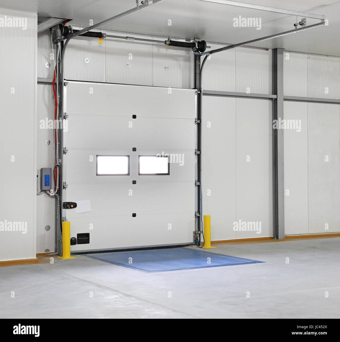 Closed roll door in distribution warehouse Stock Photo - Alamy