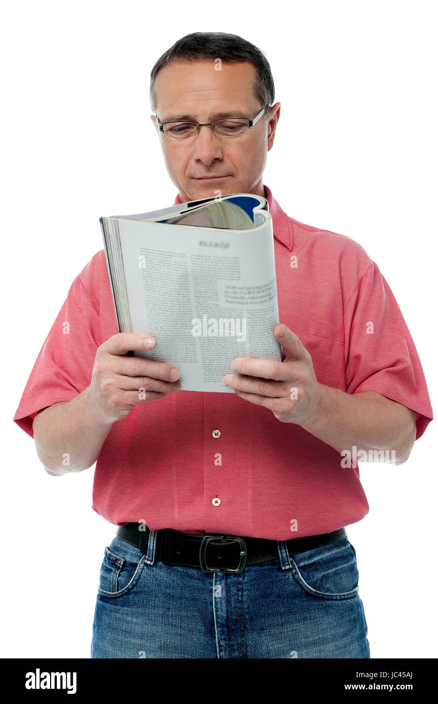 Senior man reading a book with great attention Stock Photo - Alamy