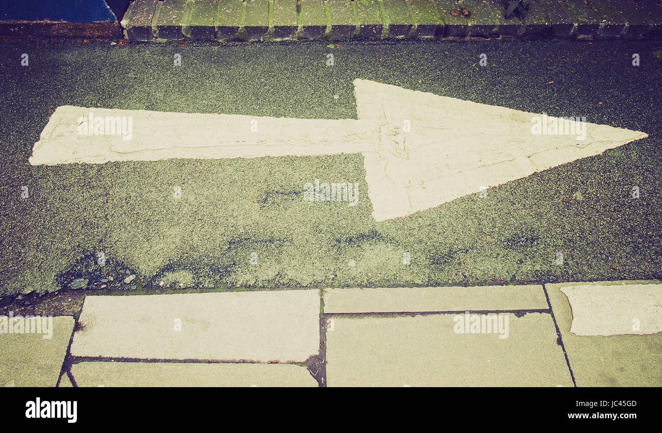 Vintage retro looking Arrow sign showing street road driving direction ...