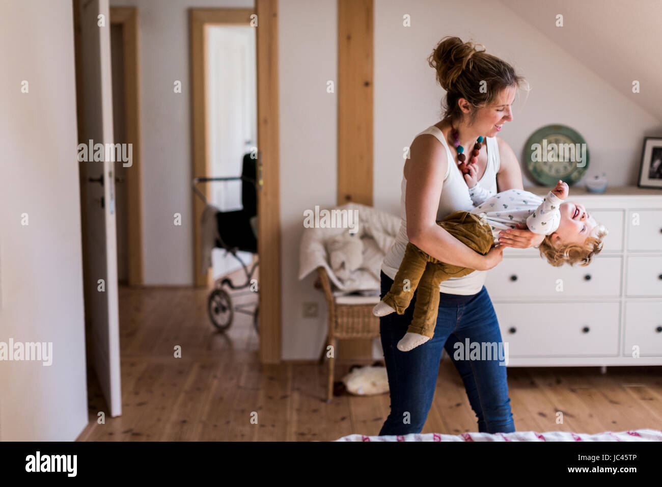 Young mother at home holding her cute little son Stock Photo - Alamy