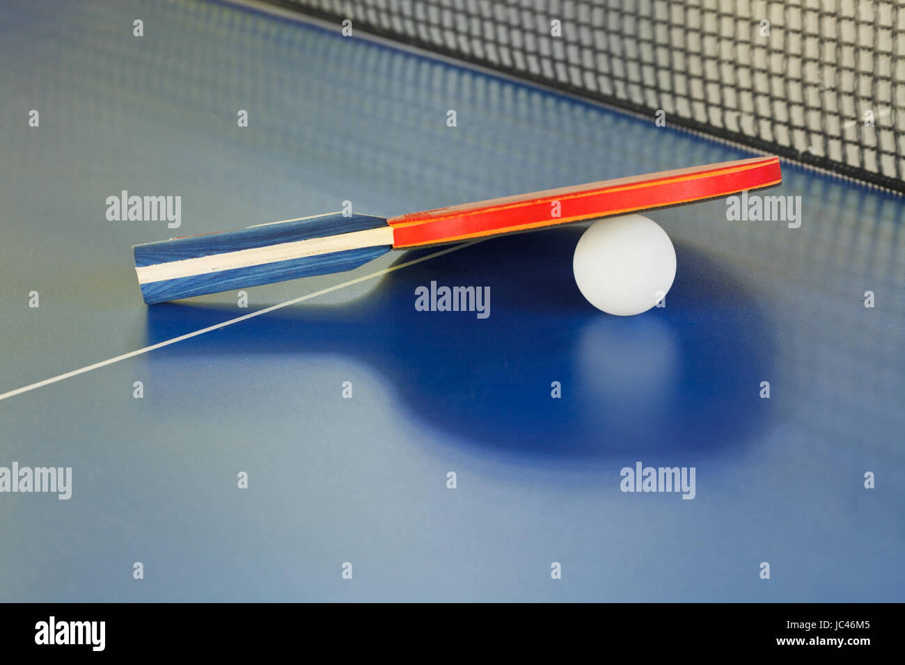 paddle, tennis ball on blue ping pong table close up Stock Photo - Alamy
