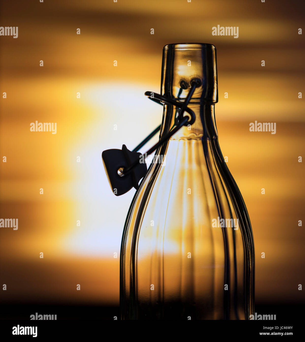 Open glass bottle in front of a creative background Stock Photo - Alamy