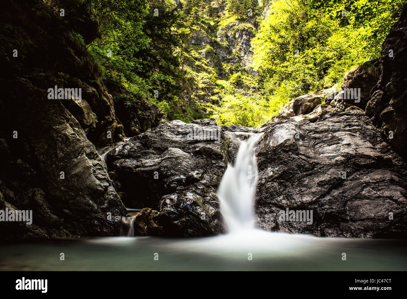 waterfall in the valley Stock Photo - Alamy