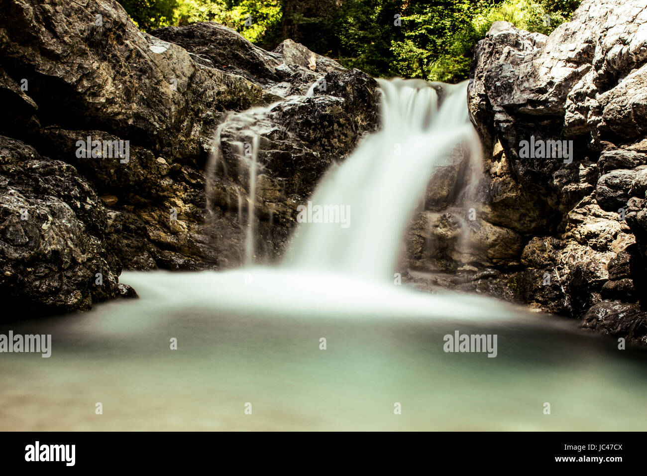 waterfall in the valley Stock Photo - Alamy