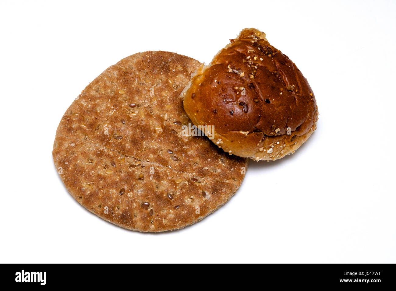 A small loaf of multigrain flat bread and a multigrain roll from above ...
