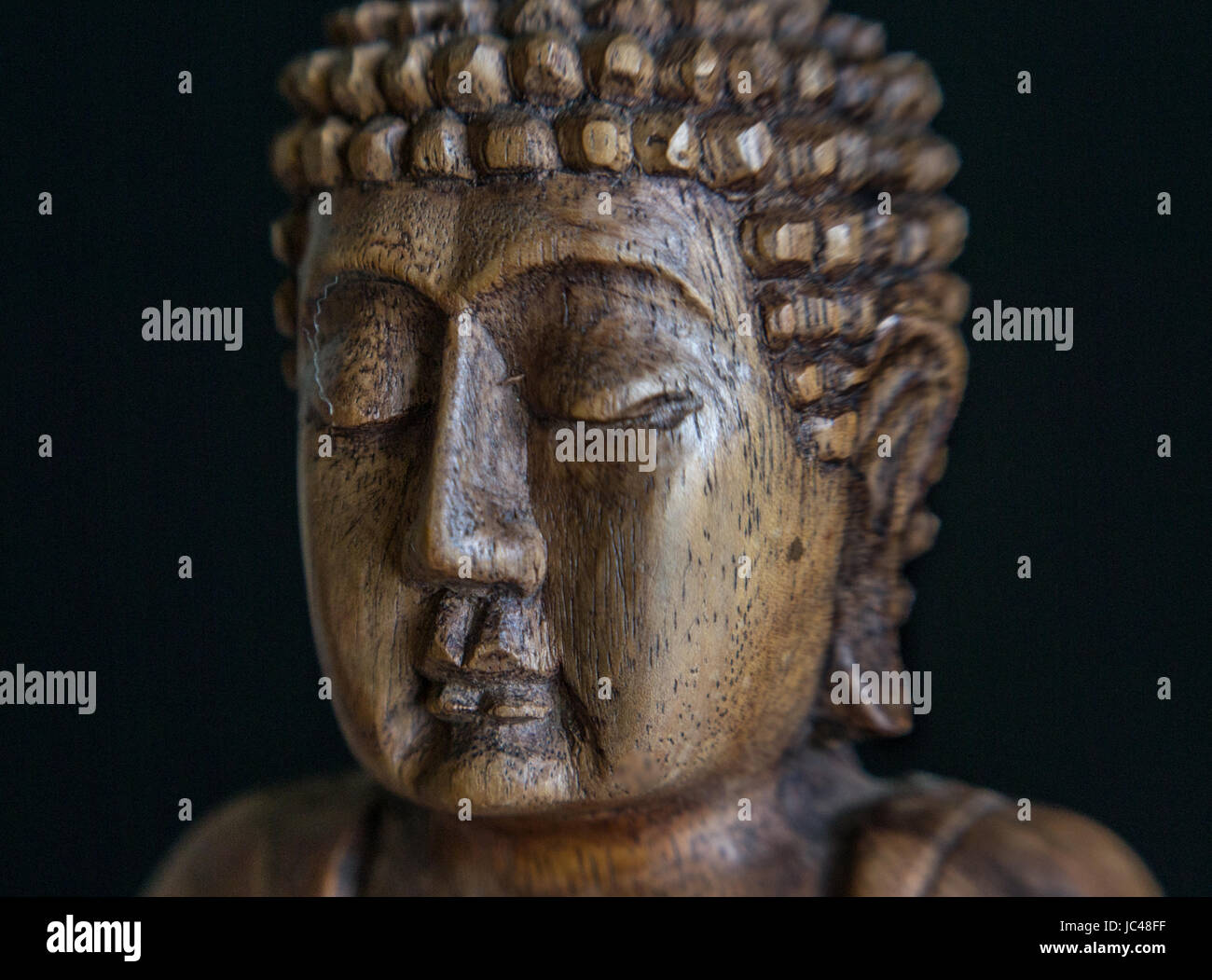 Buddha Wood Carved Statue closeup Stock Photo - Alamy