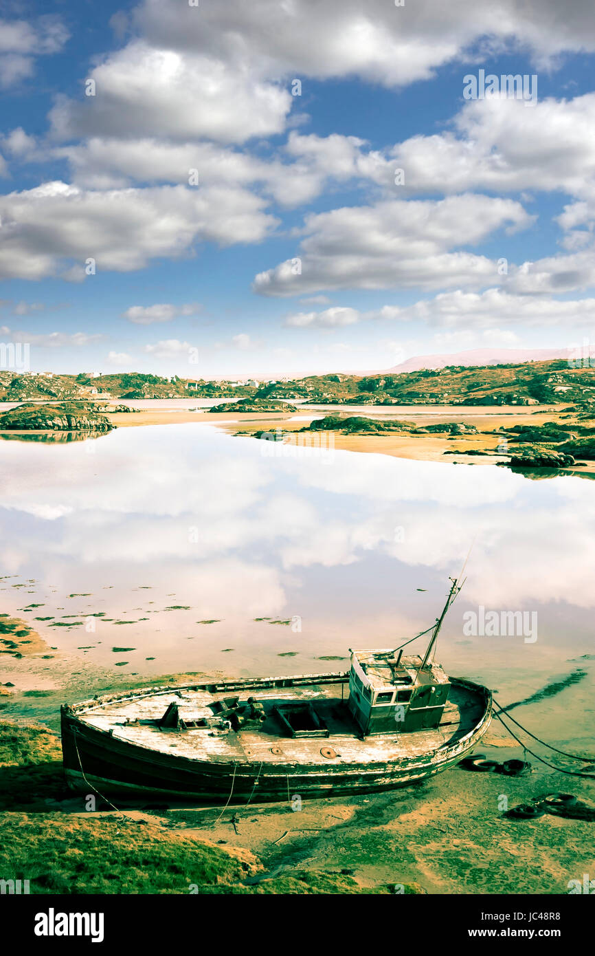 old fishing boat beached on a coastal beach in county Donegal, Ireland ...