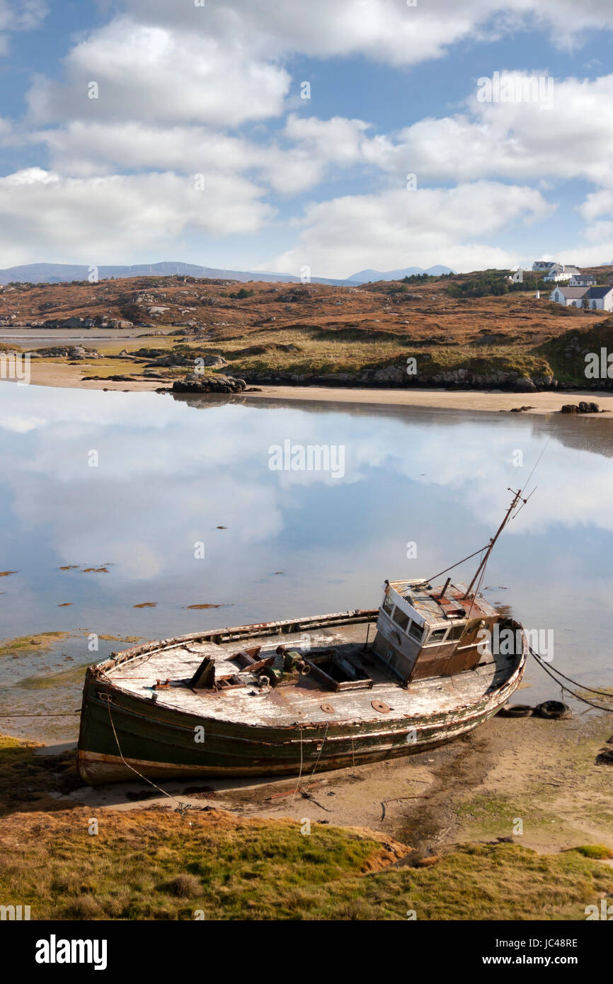 old fishing boat beached on a coastal beach in county Donegal, Ireland ...