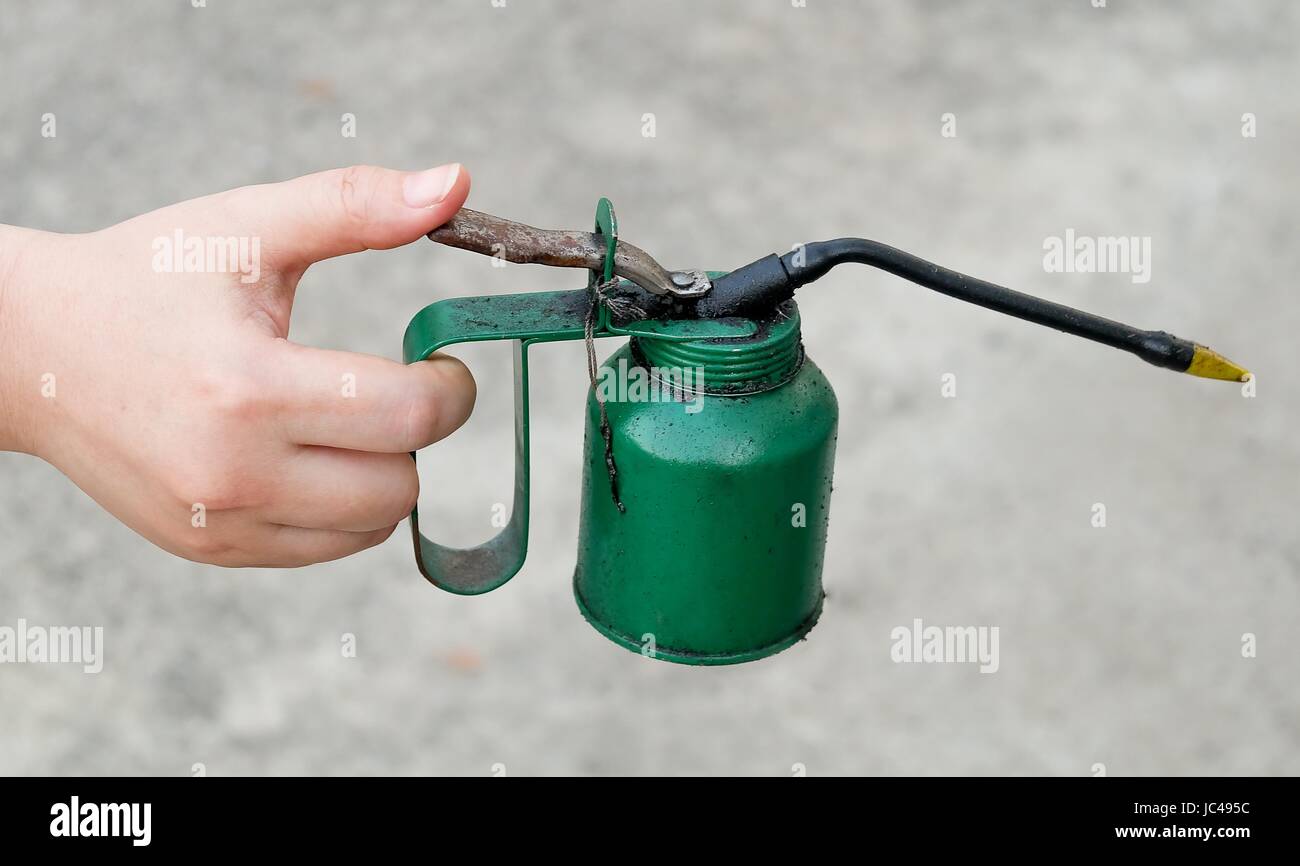 Hand Holding Old Dirty Oiler or Oil Can Coated in Grease and Dust, for ...