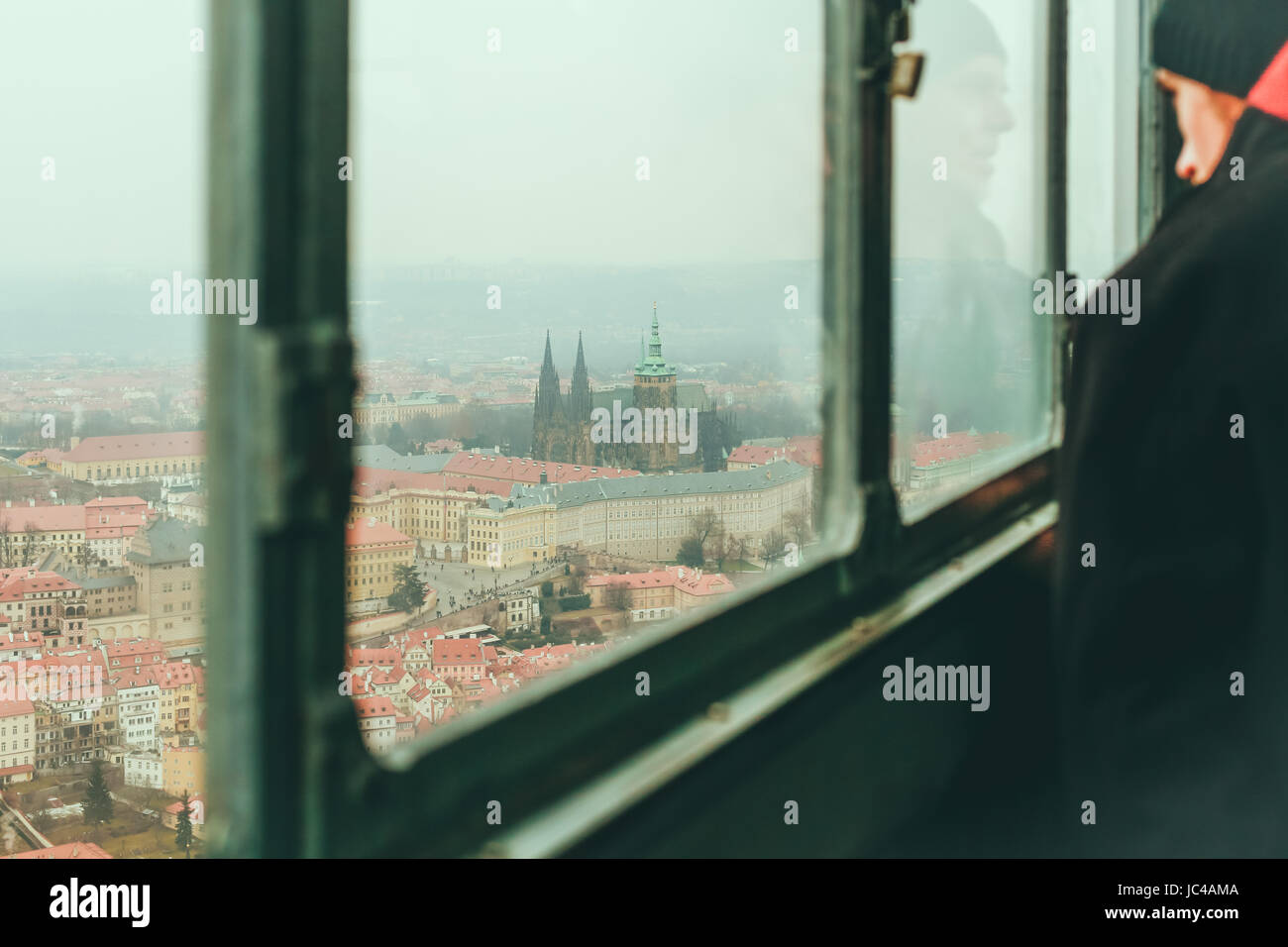 Man looking at Prague skyline from the viewing platform window at ...