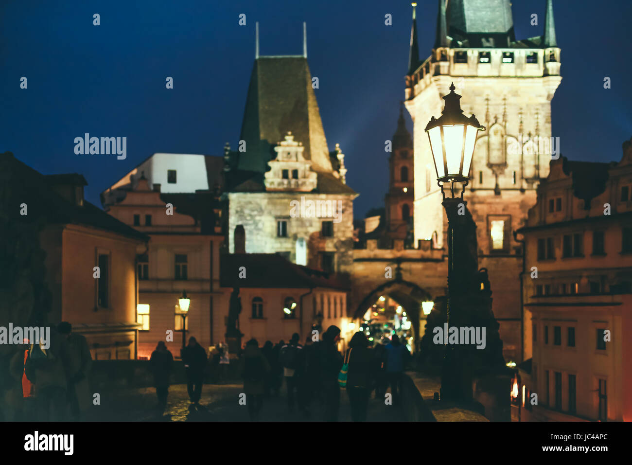 People walk on Charles Bridge, Prague, Czech Republic at night Stock ...
