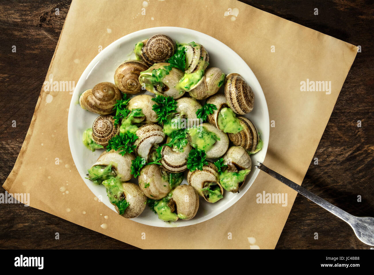 An overhead photo of escargots a la bourguignonne, a plate of snails ...