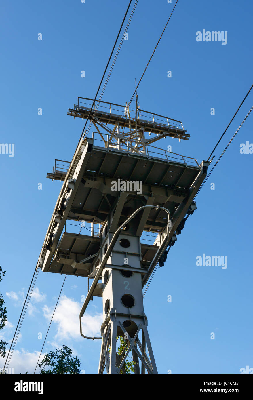 Close-up view from bellow of cableway support pillar in side sunlight ...