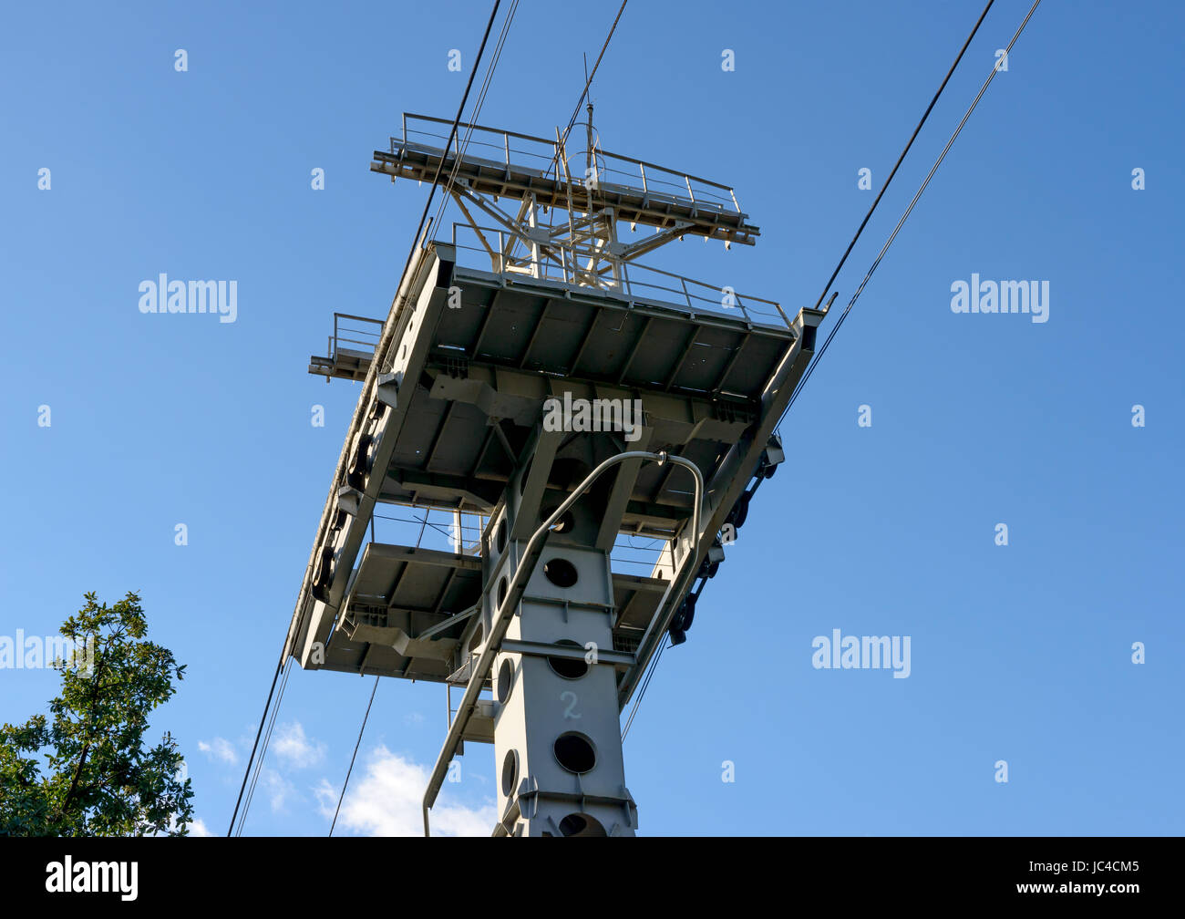 Close-up view from bellow of cableway support pillar in side sunlight ...