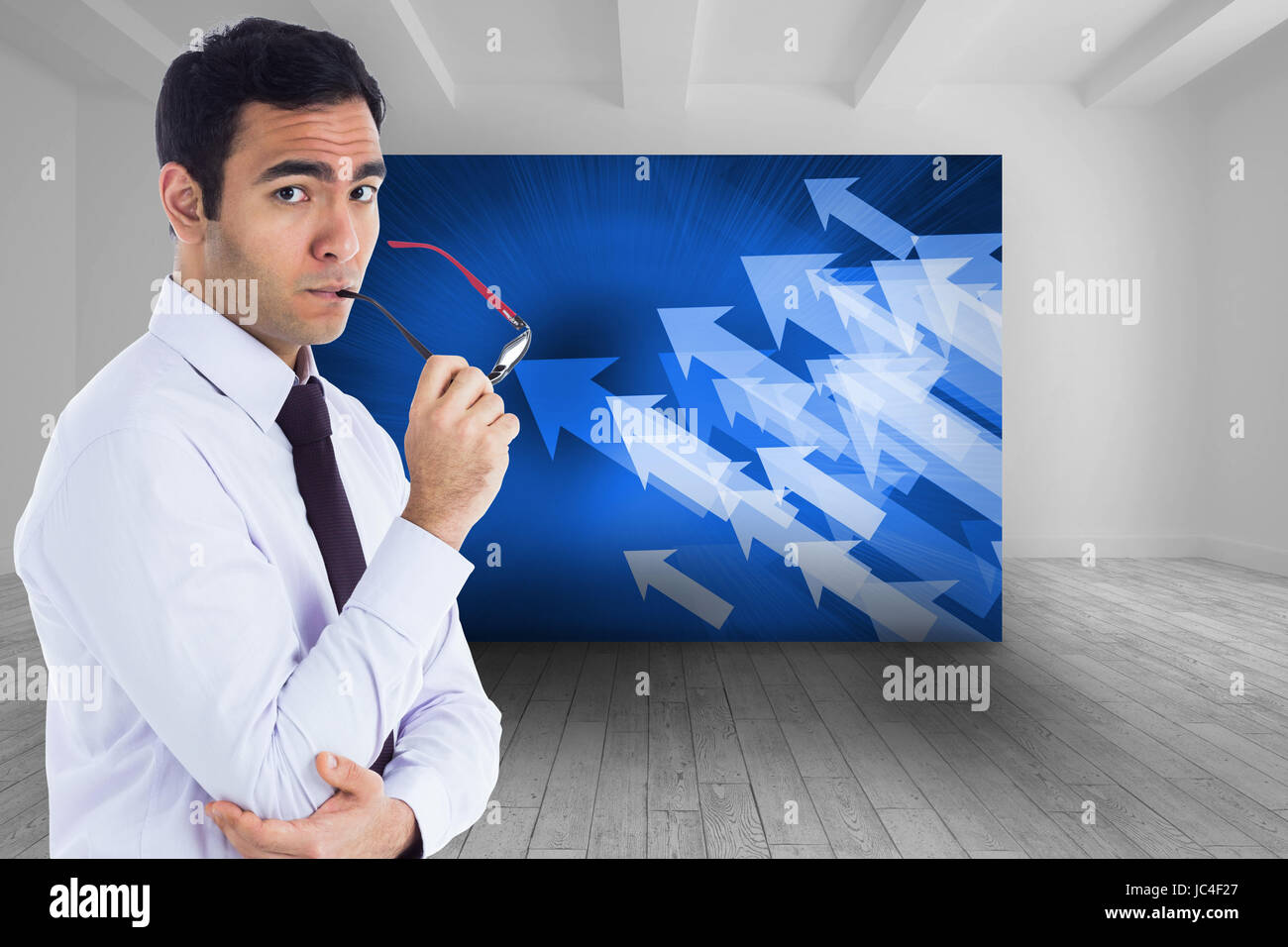 Composite image of unsmiling businessman holding Stock Photo - Alamy