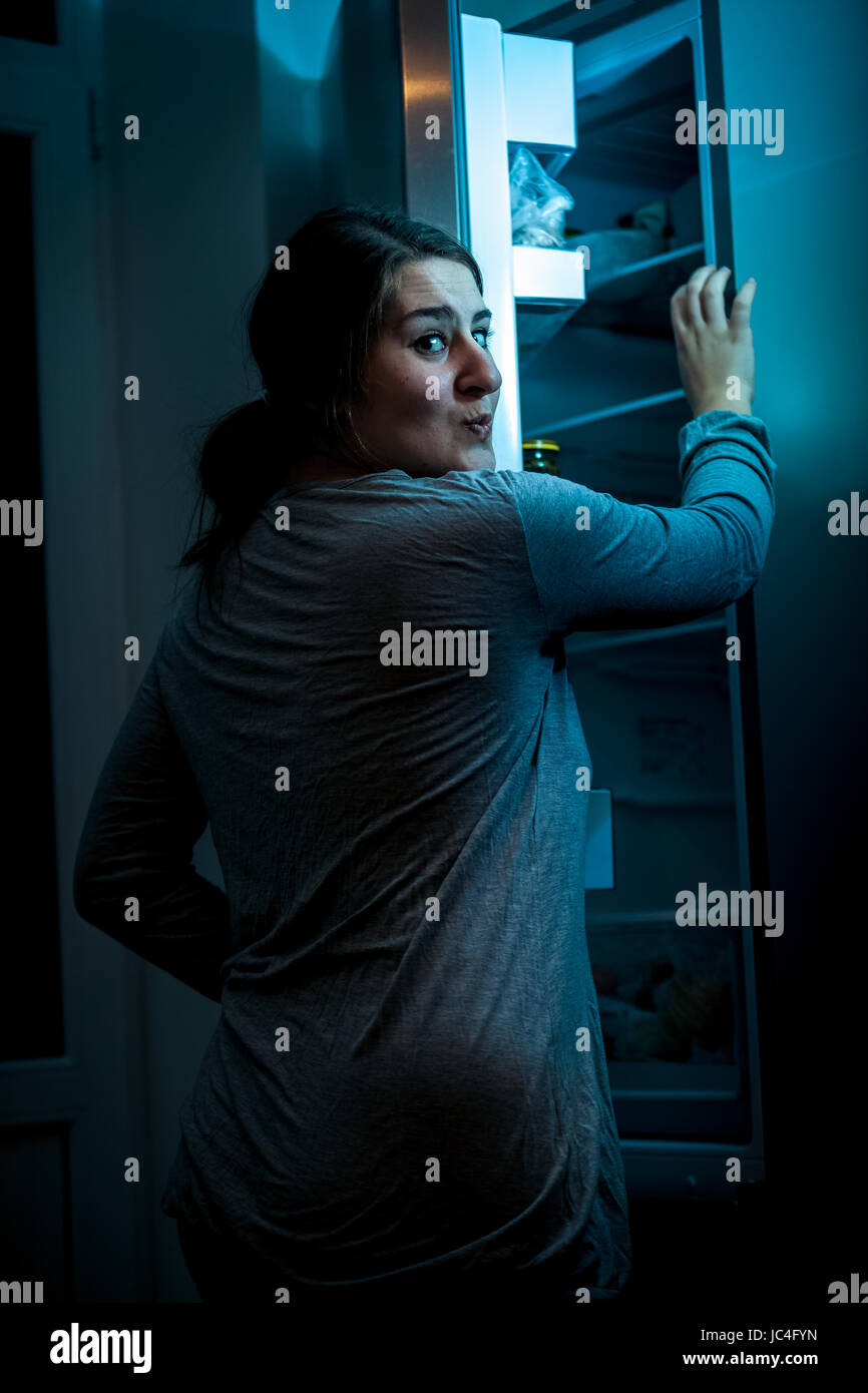 Photo at night of woman opening refrigerator Stock Photo - Alamy