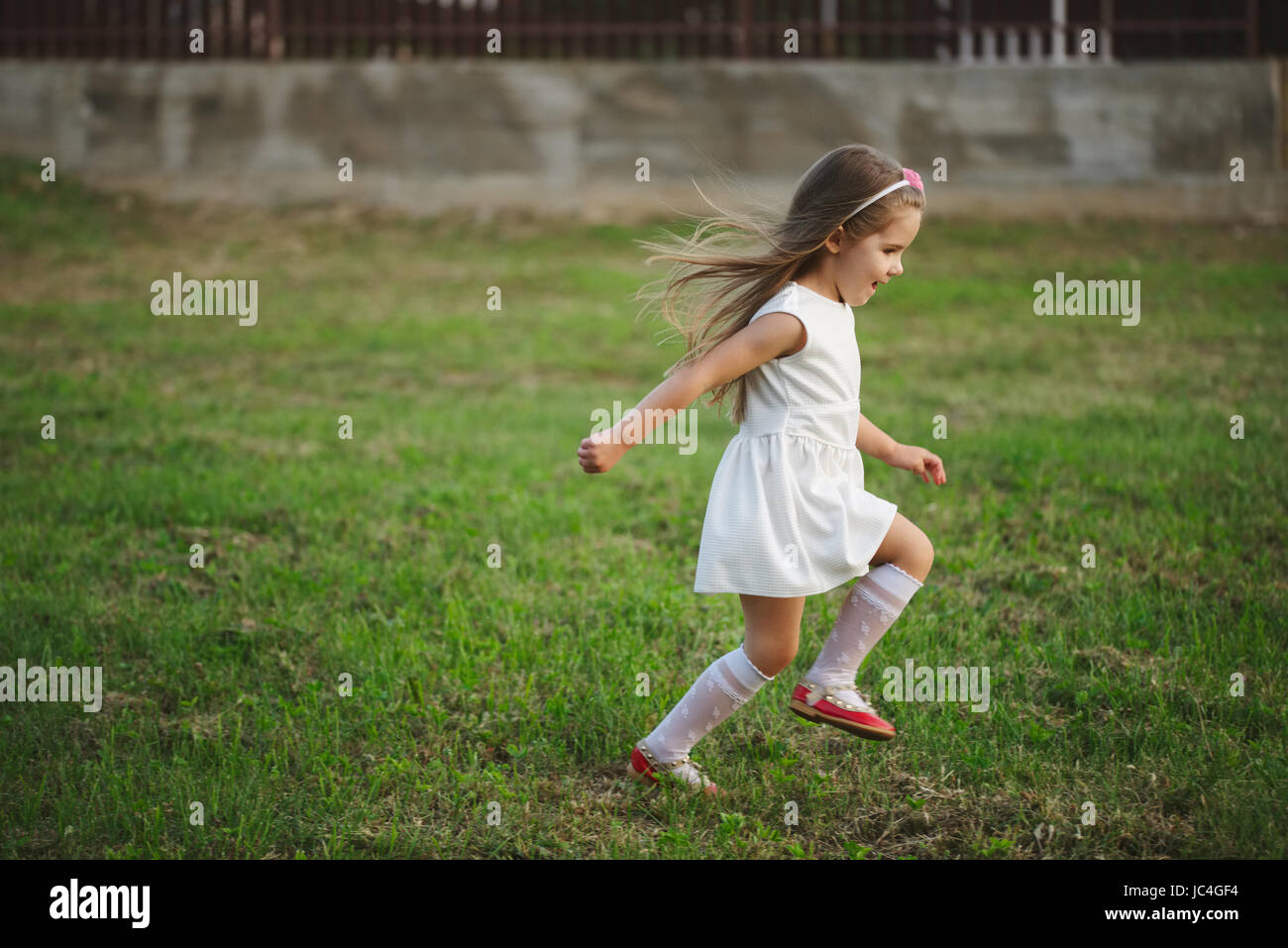 little beautiful running girl outside Stock Photo - Alamy