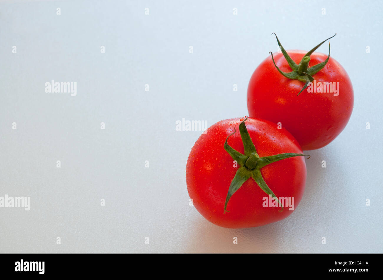 Two tomatoes. Still life Stock Photo - Alamy