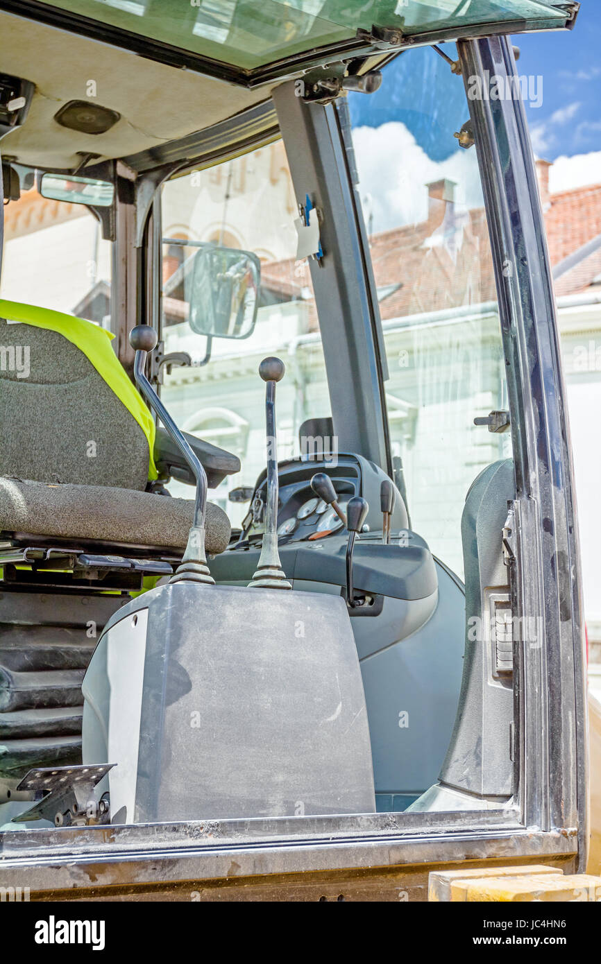 Control system in excavator's cabin, dashboard with and windscreen ...