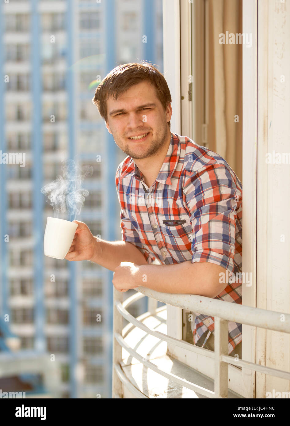 Closeup portrait of man drinking coffee on balcony Stock Photo - Alamy