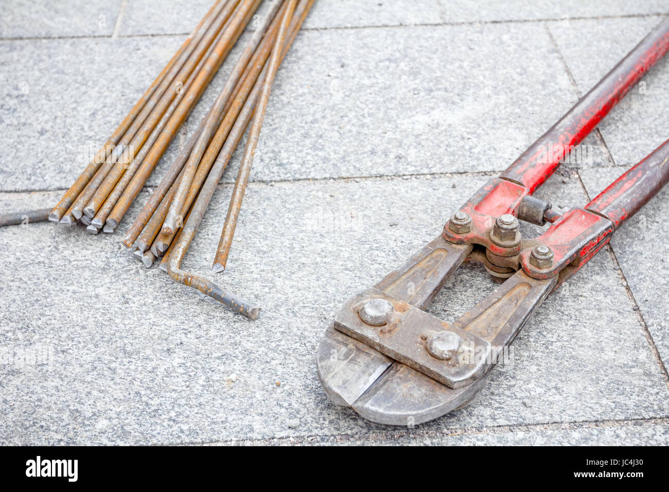 Tool for cutting reinforcement metal, bolt cutters are placed on marble ...