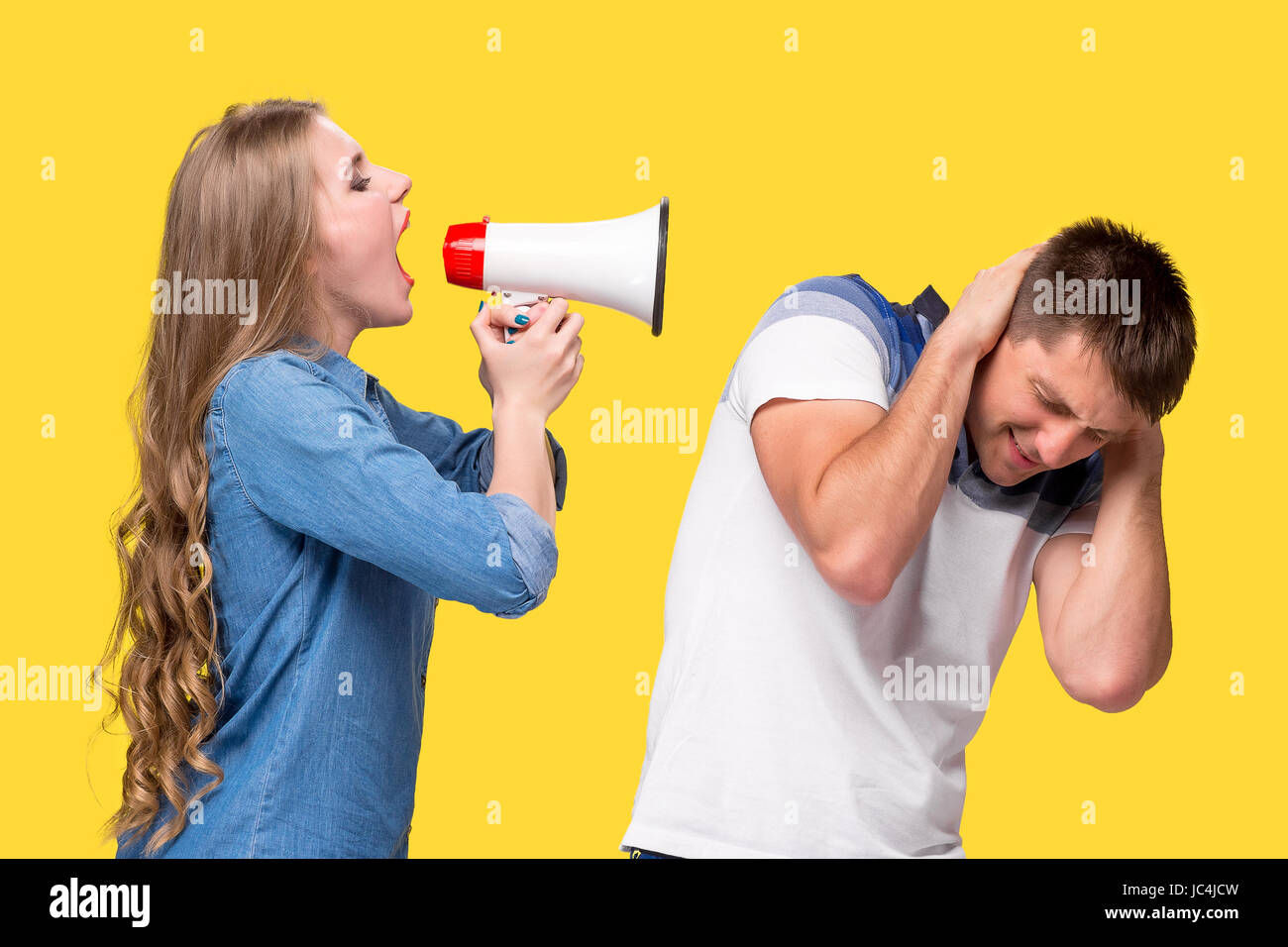 Woman shouting in megaphones at each other Stock Photo - Alamy