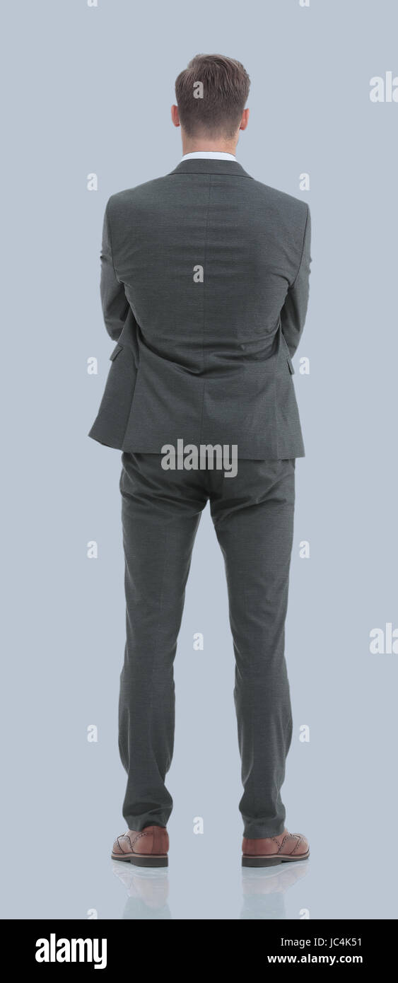 Businessman from the back - looking at something over a gray bac Stock ...