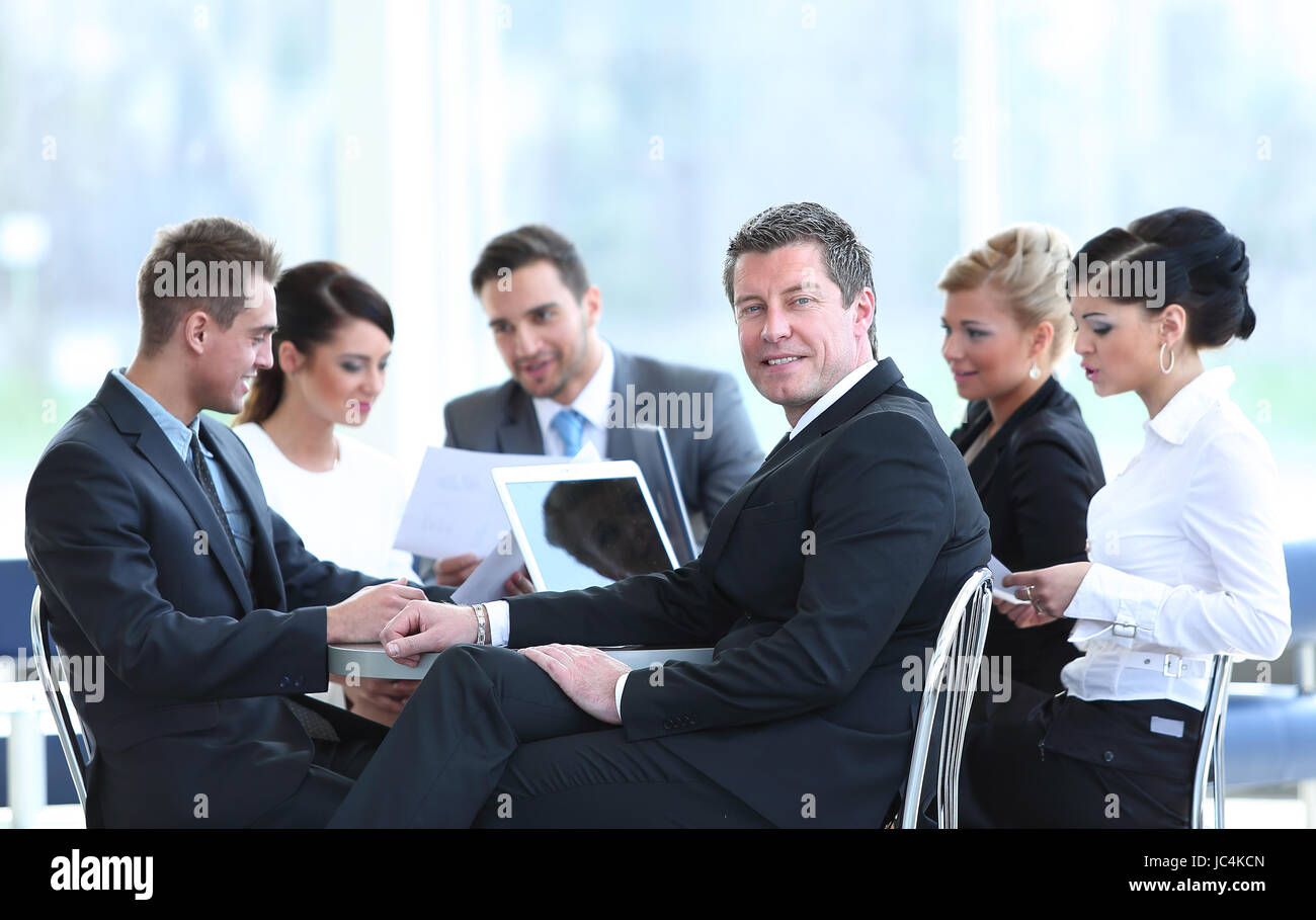 Business people working around table in modern office Stock Photo - Alamy