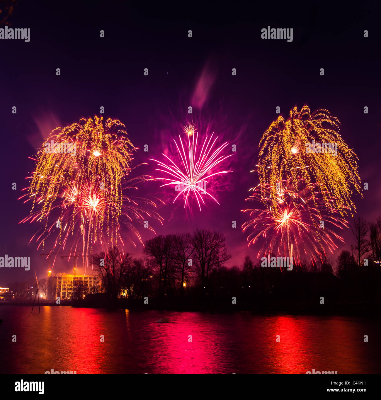 Beautiful, colorful fireworks above the river during an Independence ...
