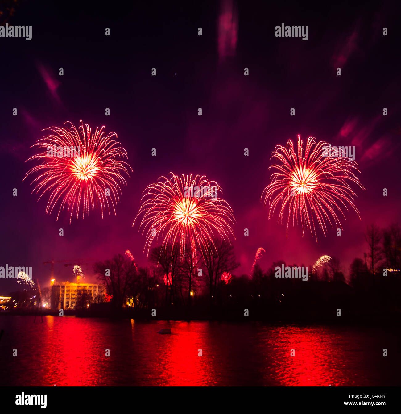 Beautiful, colorful fireworks above the river during an Independence ...