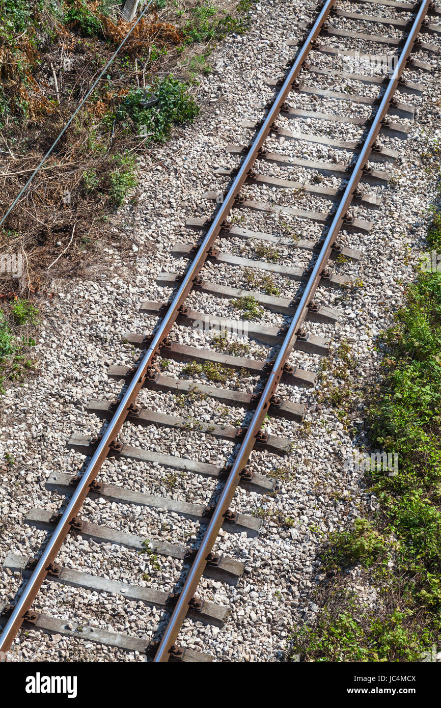 Railway track on gray gravel substrate, vertcial photo Stock Photo - Alamy