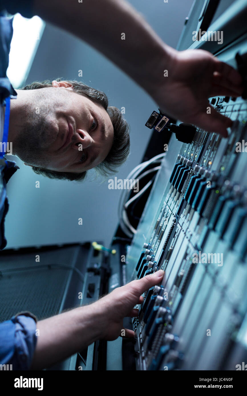 Nice male engineer working with the network server Stock Photo - Alamy