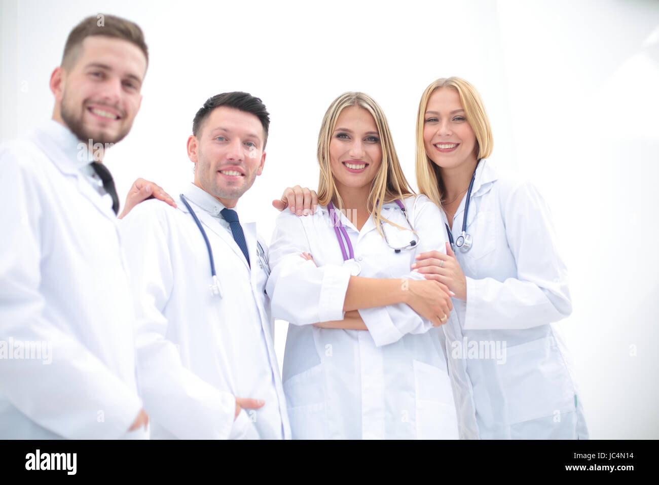 Happy and confident team of doctors posing on camera Stock Photo - Alamy