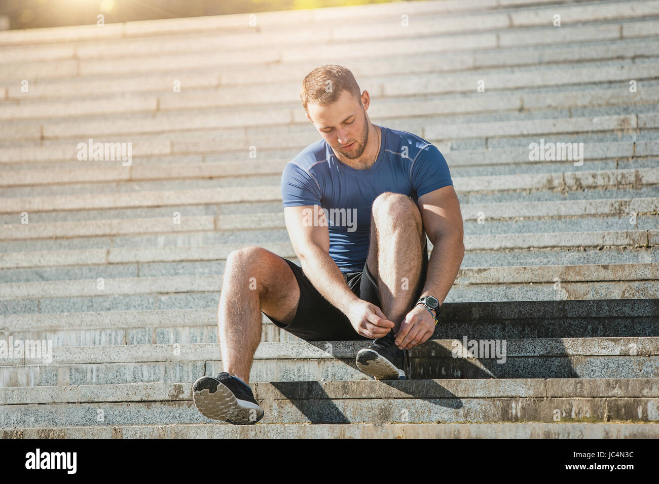 Fit man doing exercises outdoors at park Stock Photo - Alamy
