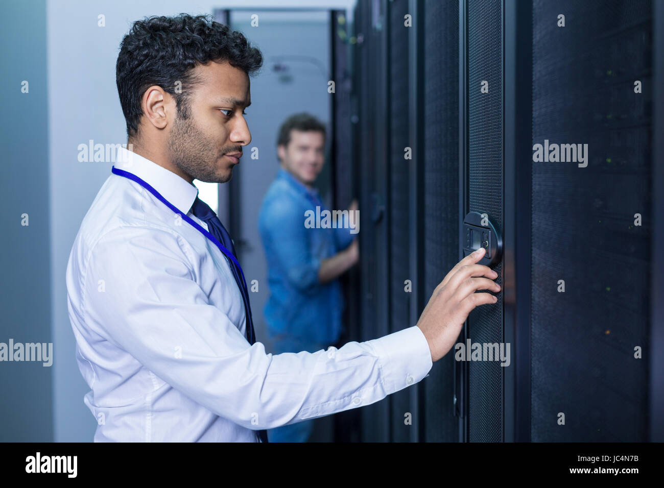 Serious nice man looking at the control panel Stock Photo - Alamy
