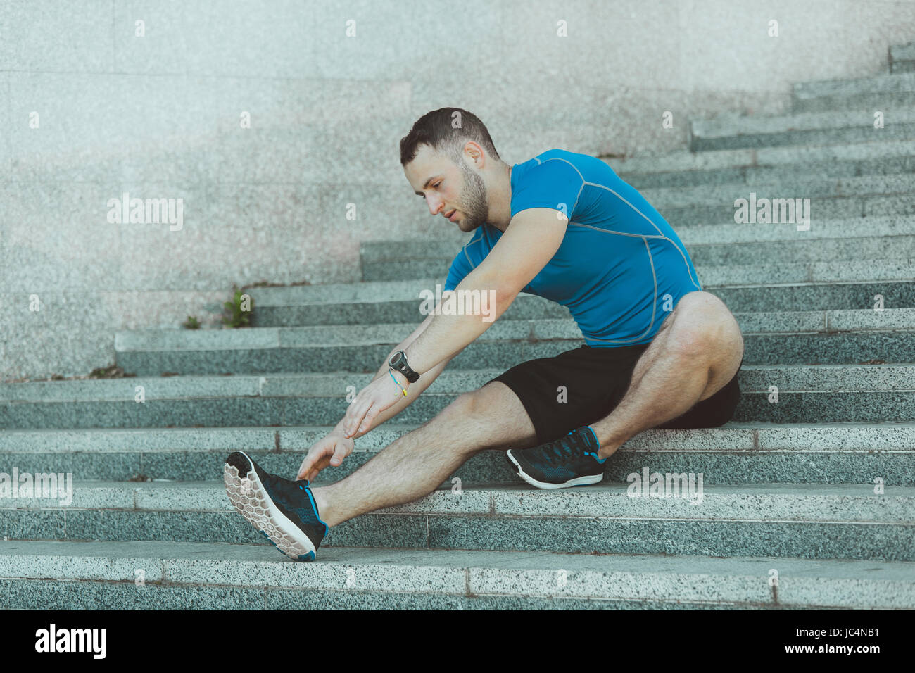 Fit man doing exercises outdoors at park Stock Photo - Alamy