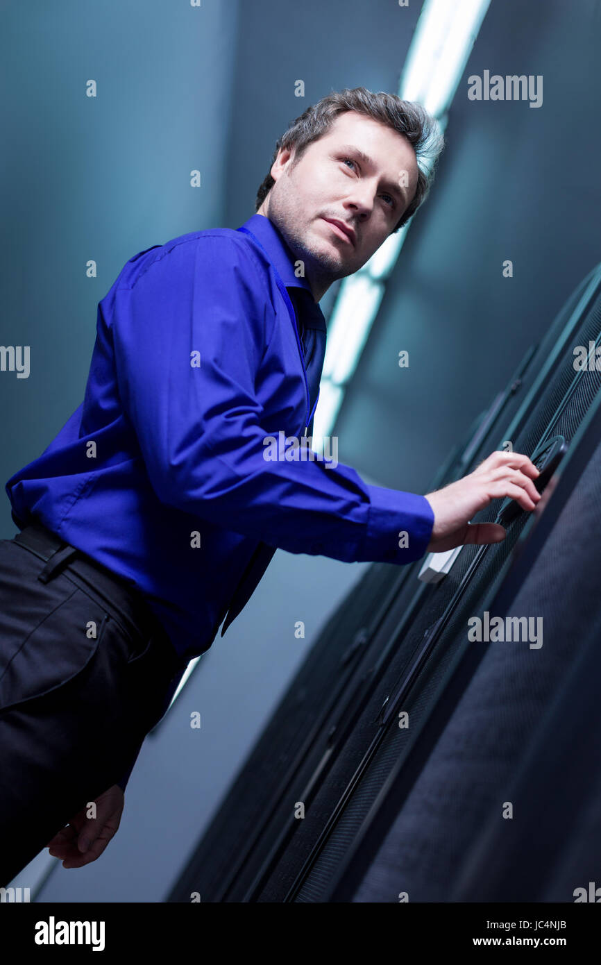 Confident pleasant man entering the password Stock Photo - Alamy