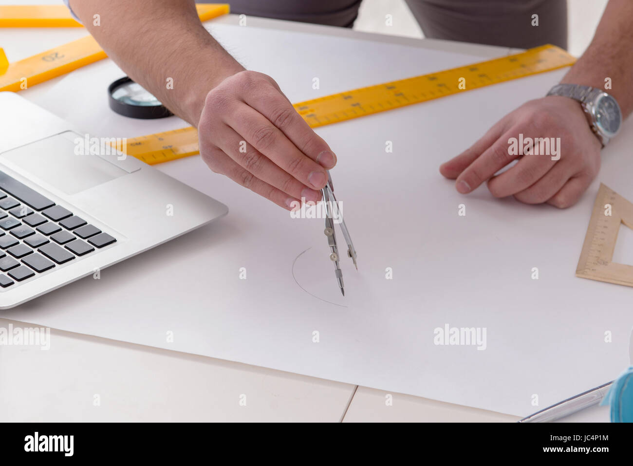 Male engineer working on drawings and blueprints Stock Photo - Alamy