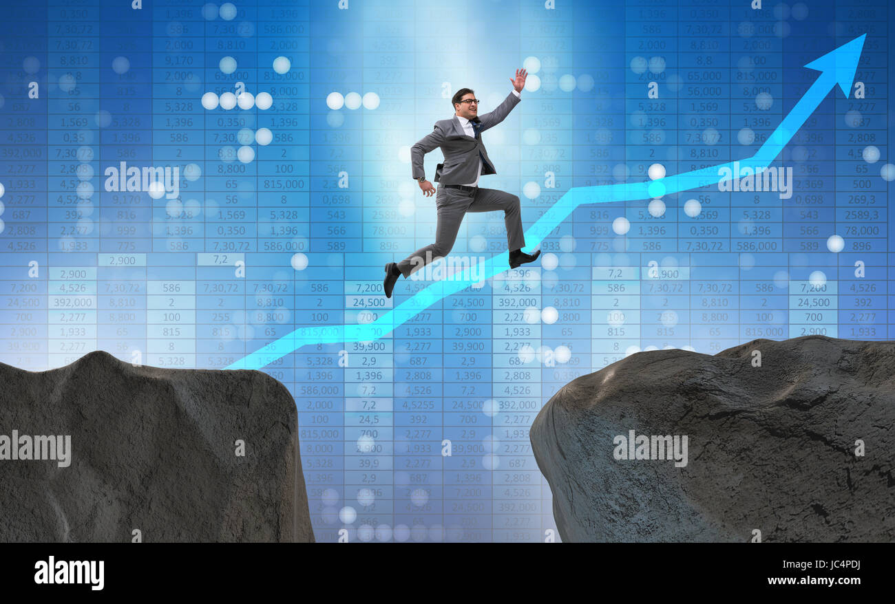 Ambitious businessman jumping over the cliff Stock Photo - Alamy