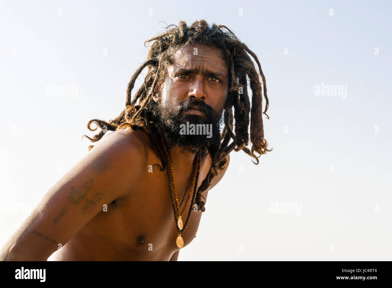 Portrait of a Sadhu, holy man, on a platform at the holy river Ganges ...