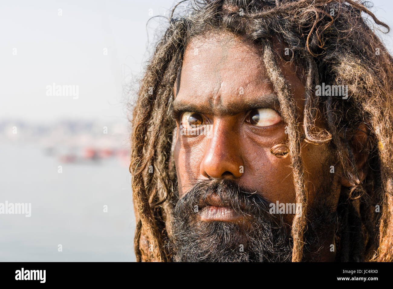 A Sadhu, holy man, is practising eye yoga asana on a platform at the ...