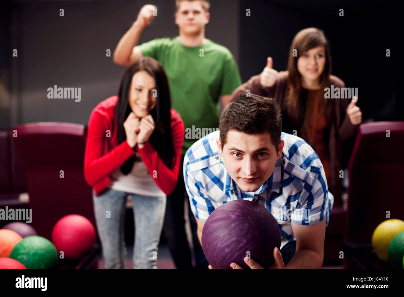 Friends bowling together Stock Photo - Alamy