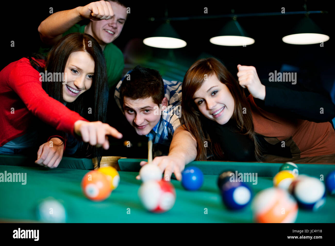 Friends playing billiard Stock Photo - Alamy
