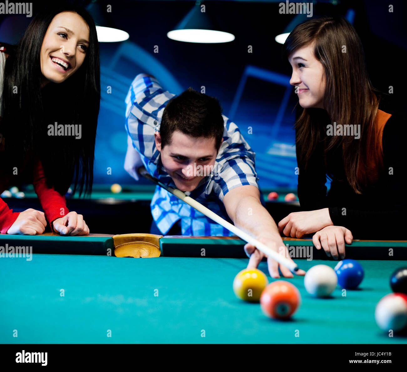 Friends playing billiard Stock Photo - Alamy
